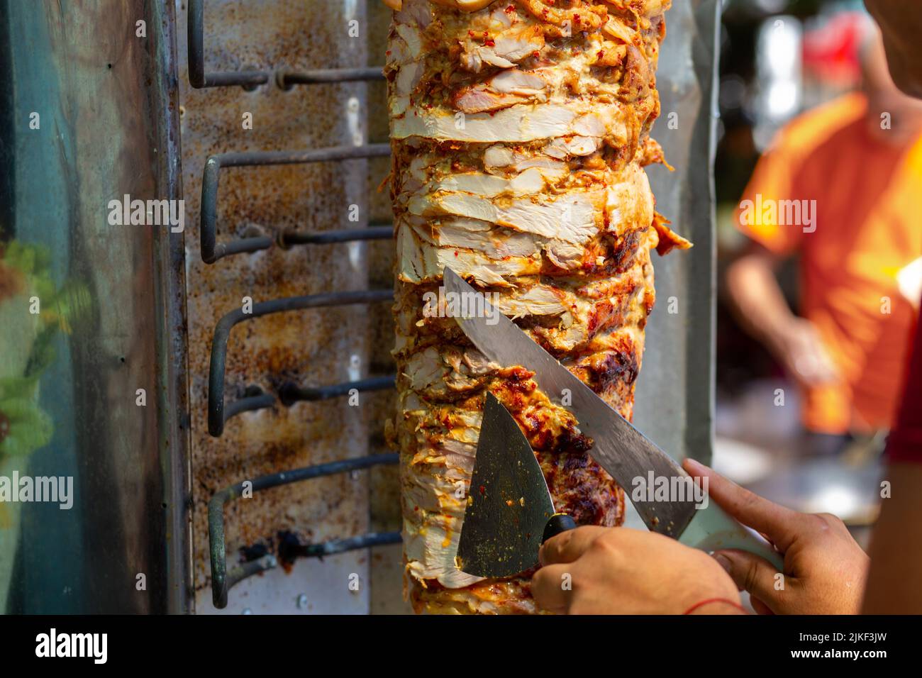 Chef cutting with doner knife Traditional Turkish Doner Kebab meat ...