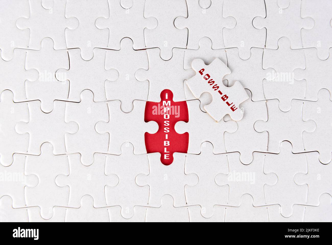White jigsaw puzzle pieces background and text on red. Life possibility ...