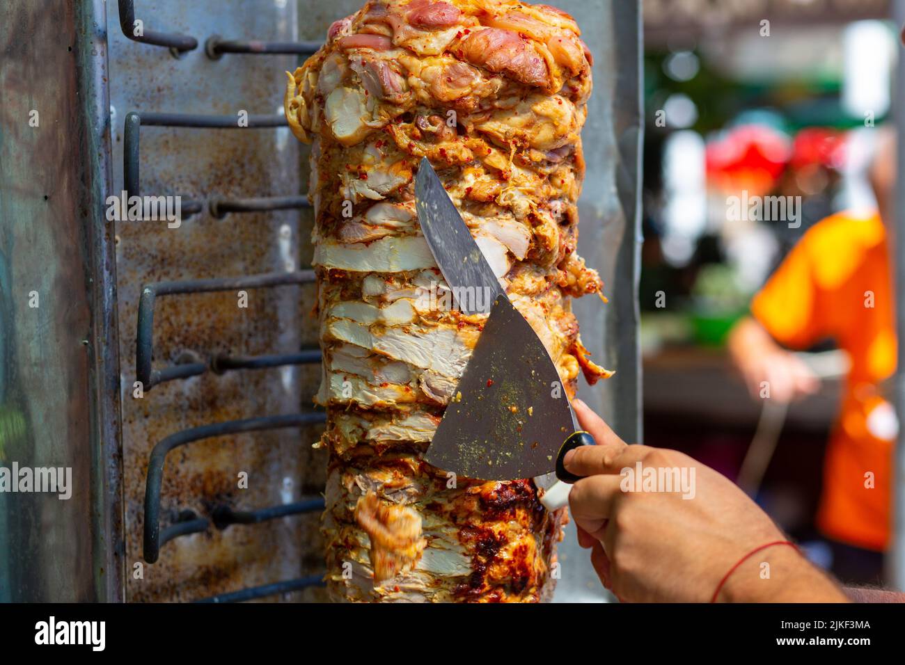 Chef cutting with doner knife Traditional Turkish Doner Kebab meat ...