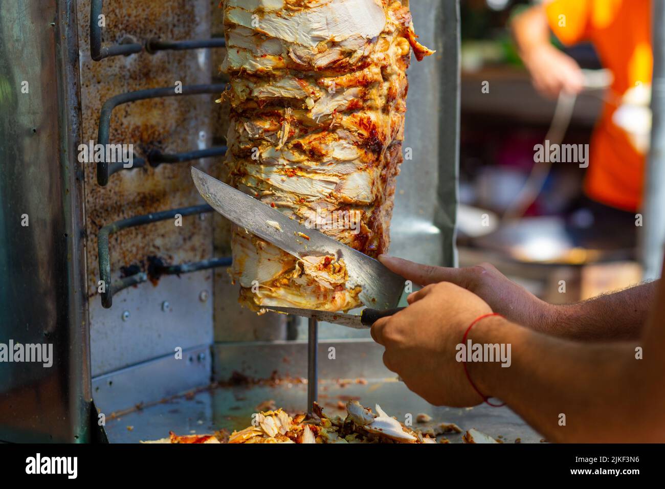 Chef cutting with doner knife Traditional Turkish Doner Kebab meat ...