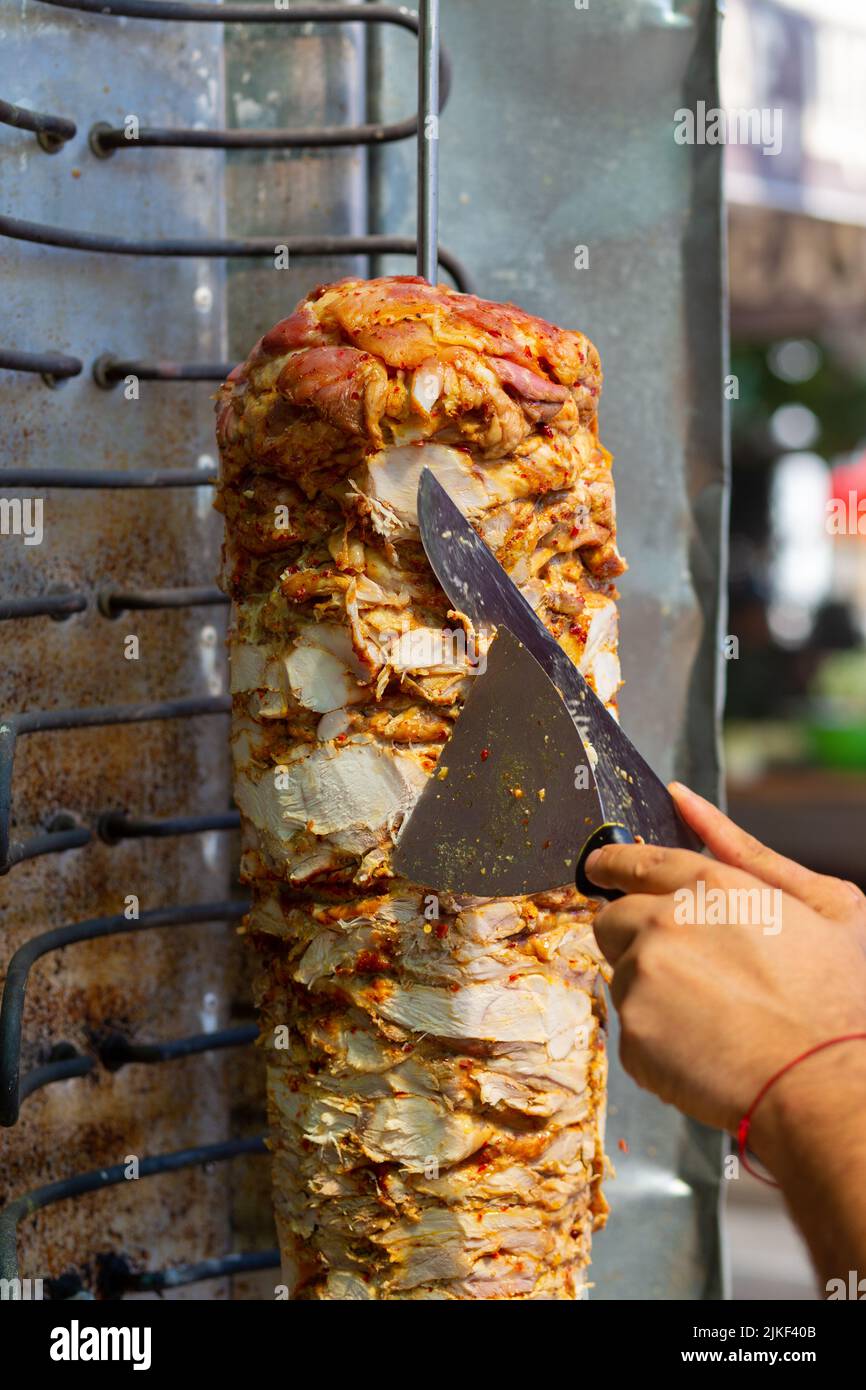 Chef cutting with doner knife Traditional Turkish Doner Kebab meat ...