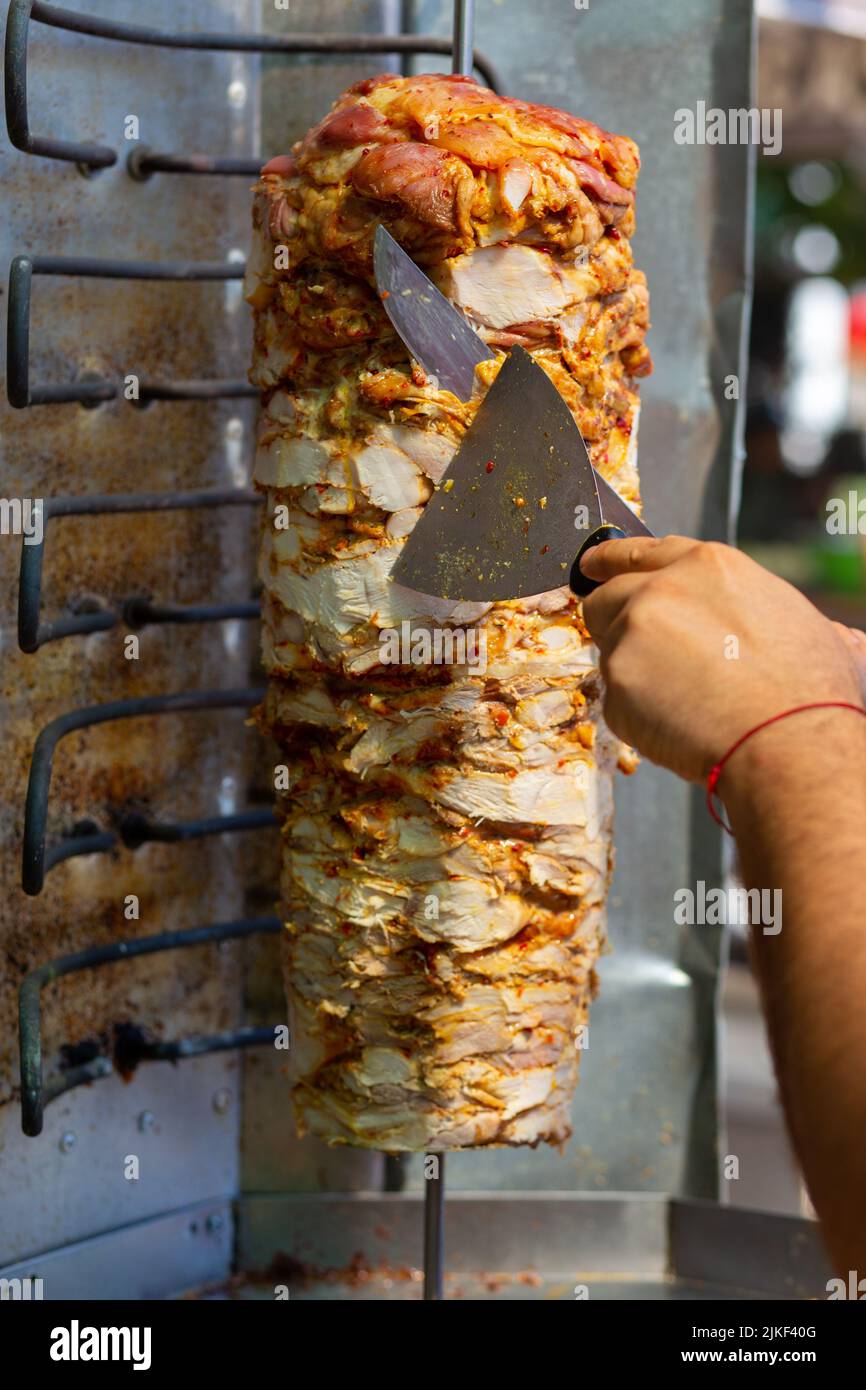 Chef cutting with doner knife Traditional Turkish Doner Kebab meat ...