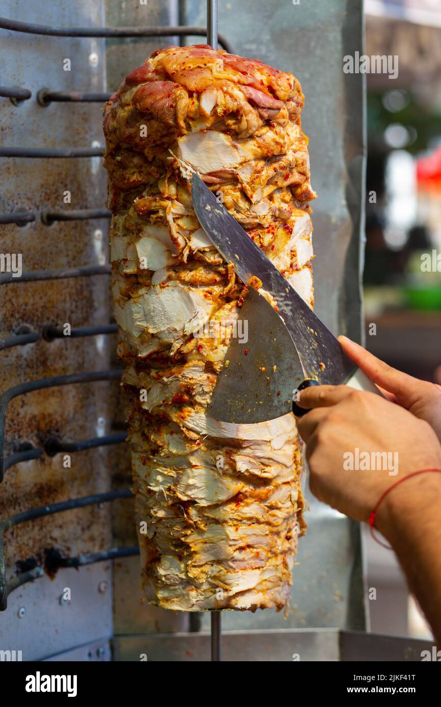 Chef cutting with doner knife Traditional Turkish Doner Kebab meat ...