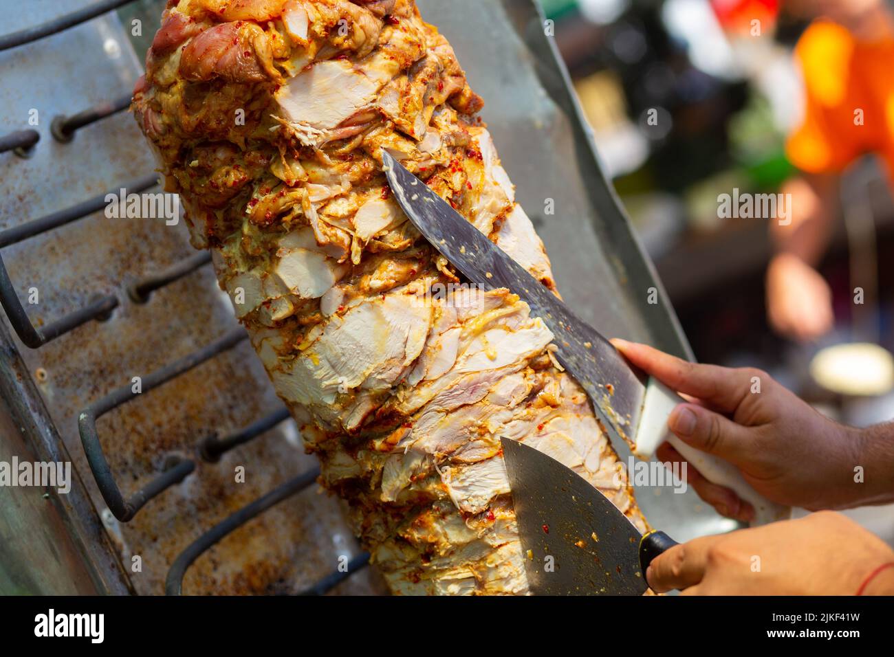 Chef cutting with doner knife Traditional Turkish Doner Kebab meat ...
