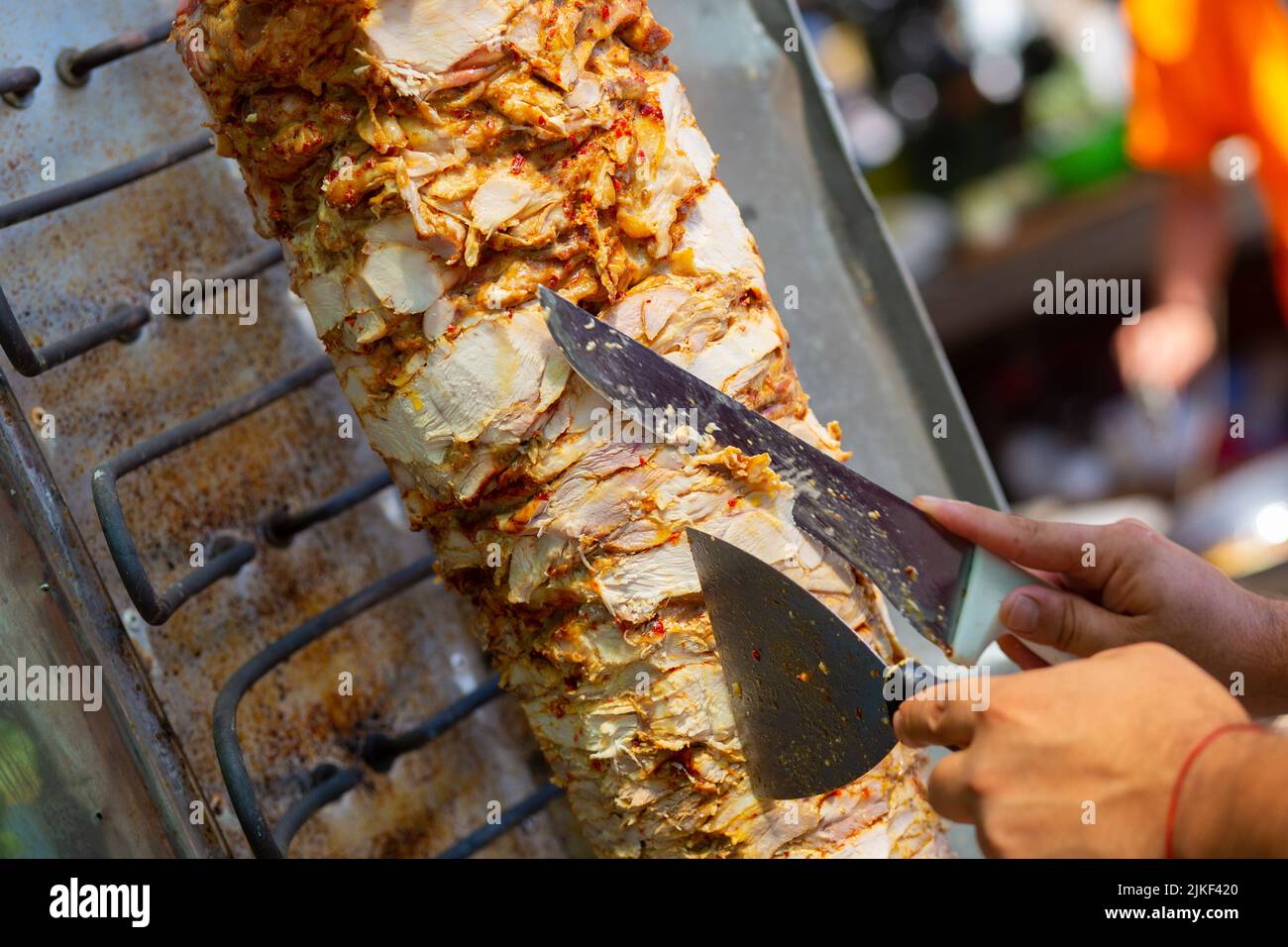 Chef cutting with doner knife Traditional Turkish Doner Kebab meat ...