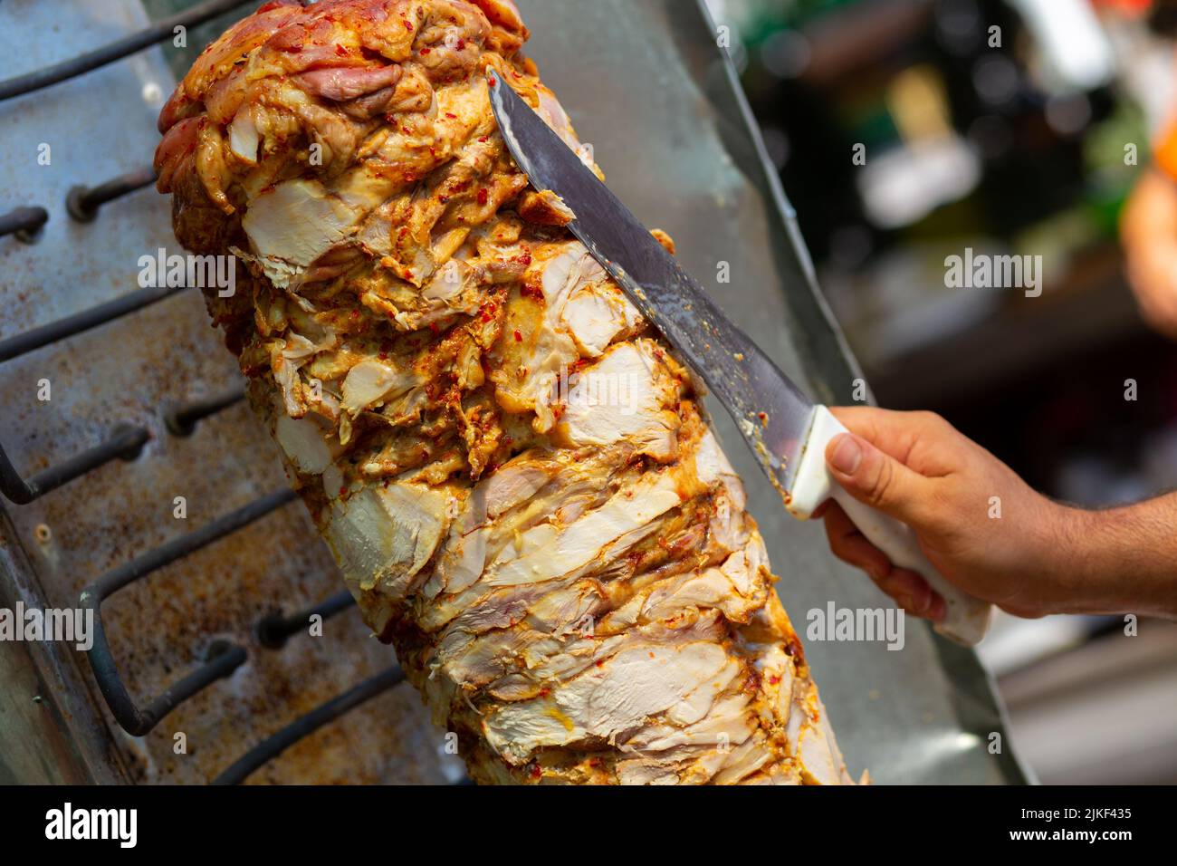 Chef cutting with doner knife Traditional Turkish Doner Kebab meat ...