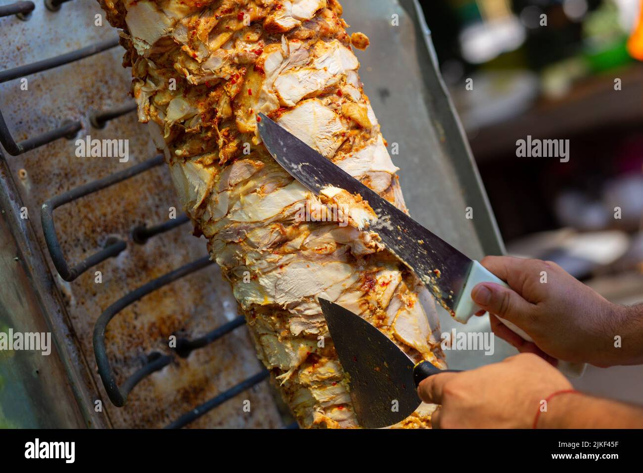 Chef cutting with doner knife Traditional Turkish Doner Kebab meat ...