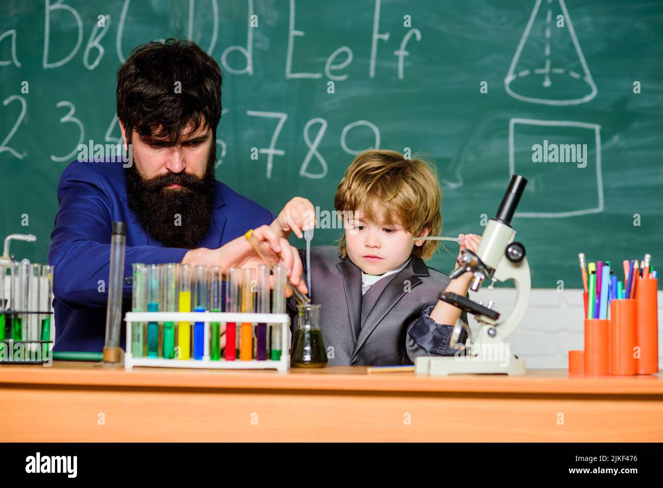 father and son child at school. Chemistry beaker experiment. bearded ...