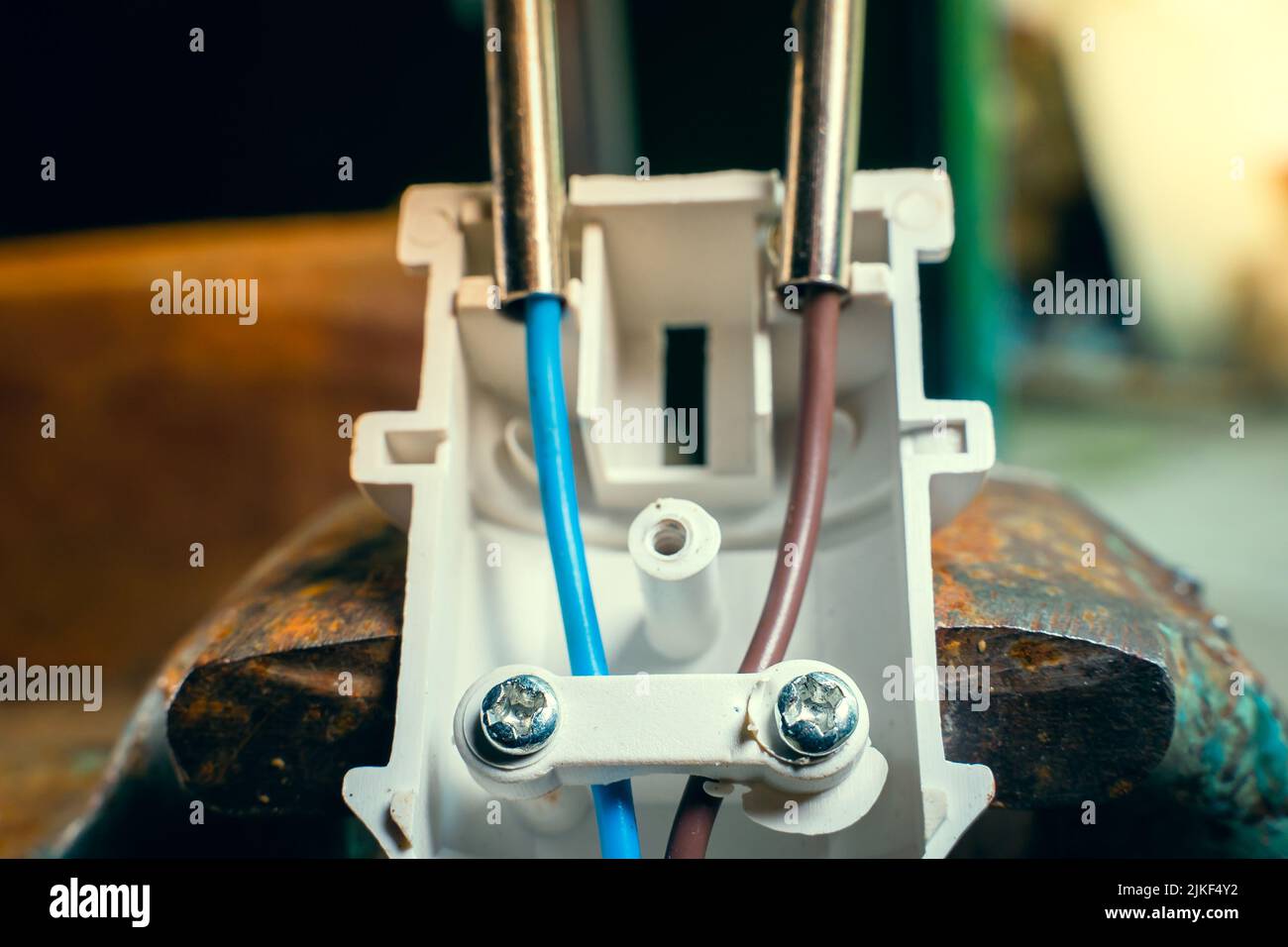 Connecting the wires of an electrical appliance into an electrical plug ...