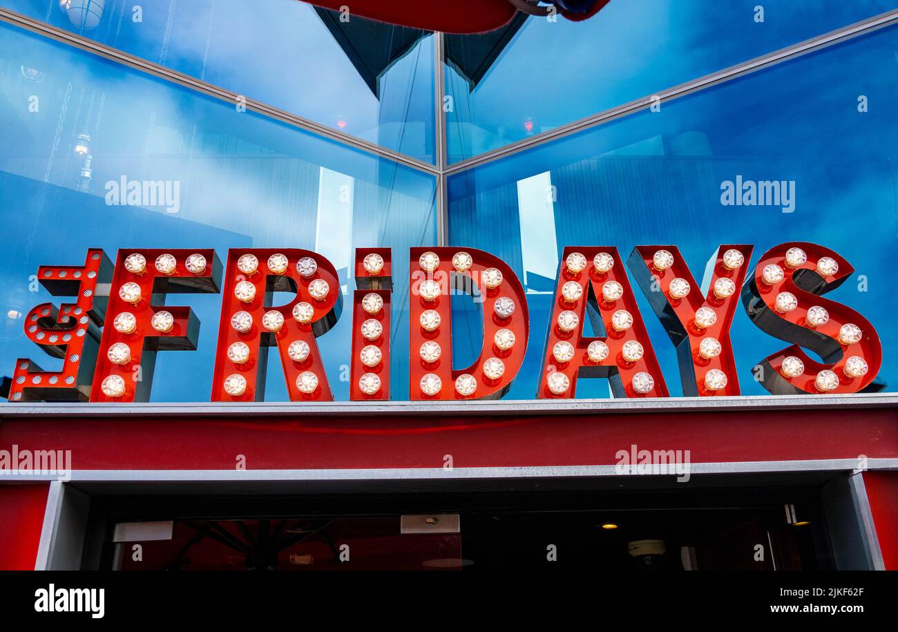 Sign above. entrance to TGI Fridays, an American fast food restaurant ...