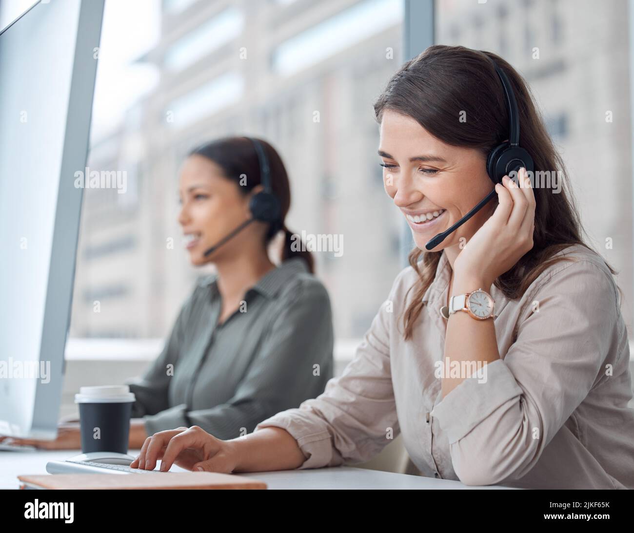 What can I do for you today. two young female call center workers in ...