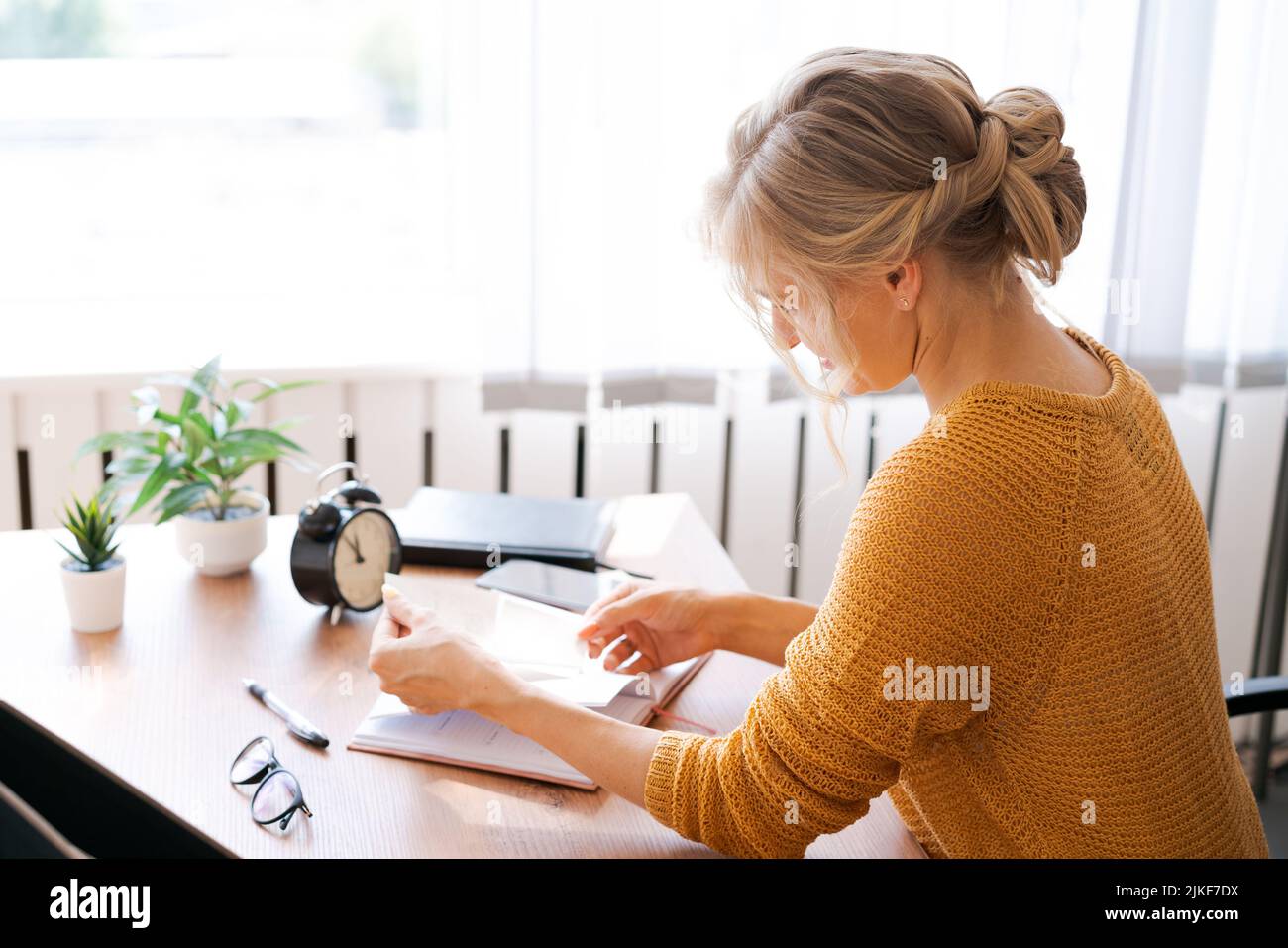 Pensive female administrative assistant. Reading information report in ...