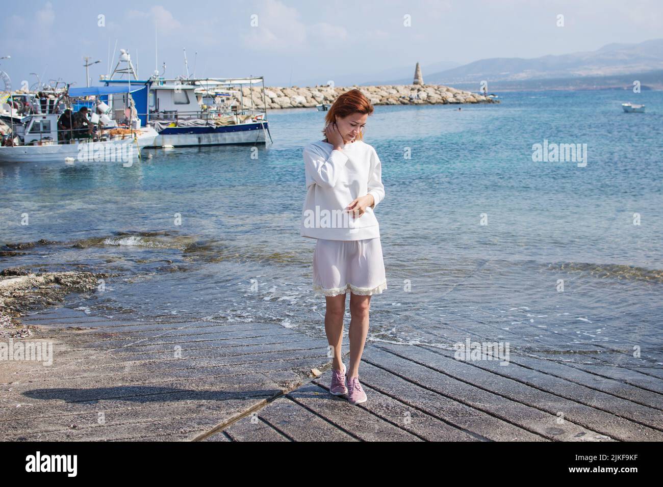Traveling by Cyprus. Young woman enjoying the view of bay on the sea ...