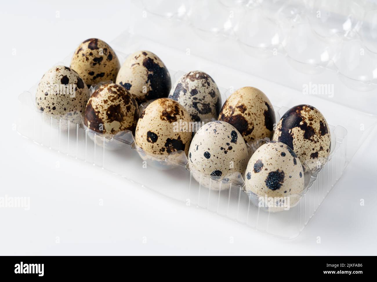 Quail eggs in a pack placed on a white background Stock Photo - Alamy