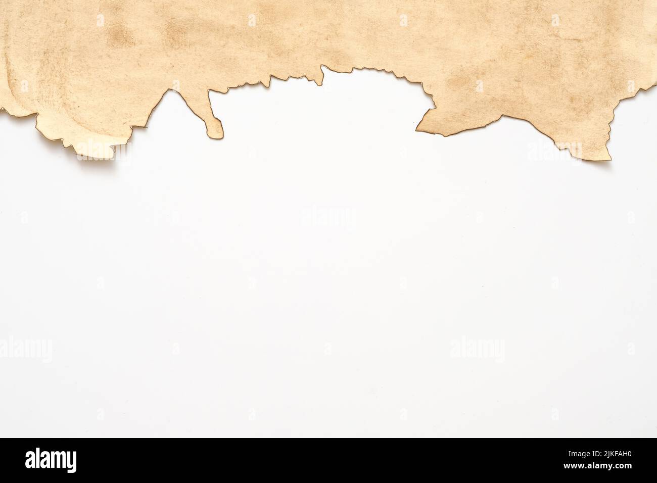 aged beige paper burnt edge white background Stock Photo - Alamy