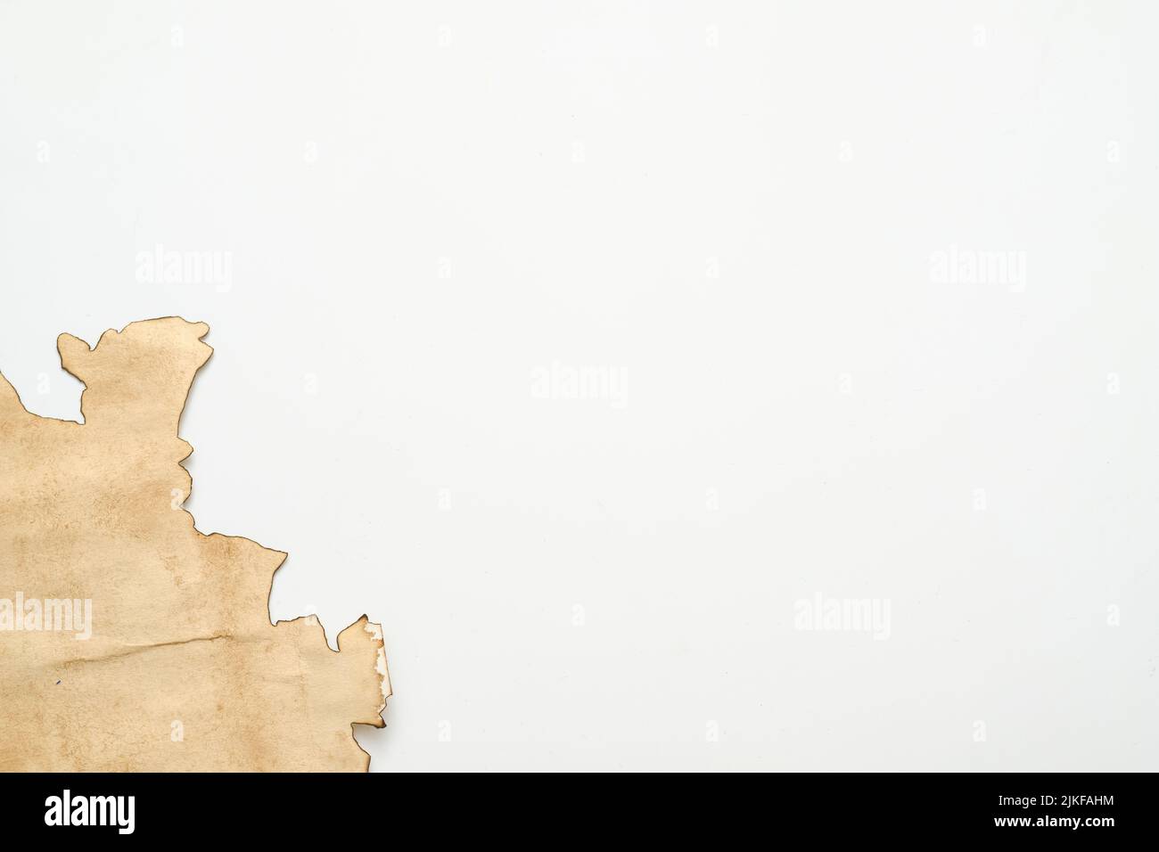 aged beige paper piece burnt edge white background Stock Photo - Alamy