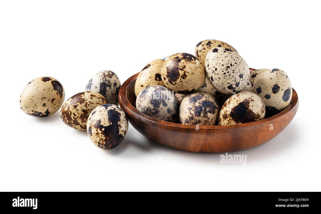 Quail eggs in a wooden dish set against a white background Stock Photo ...