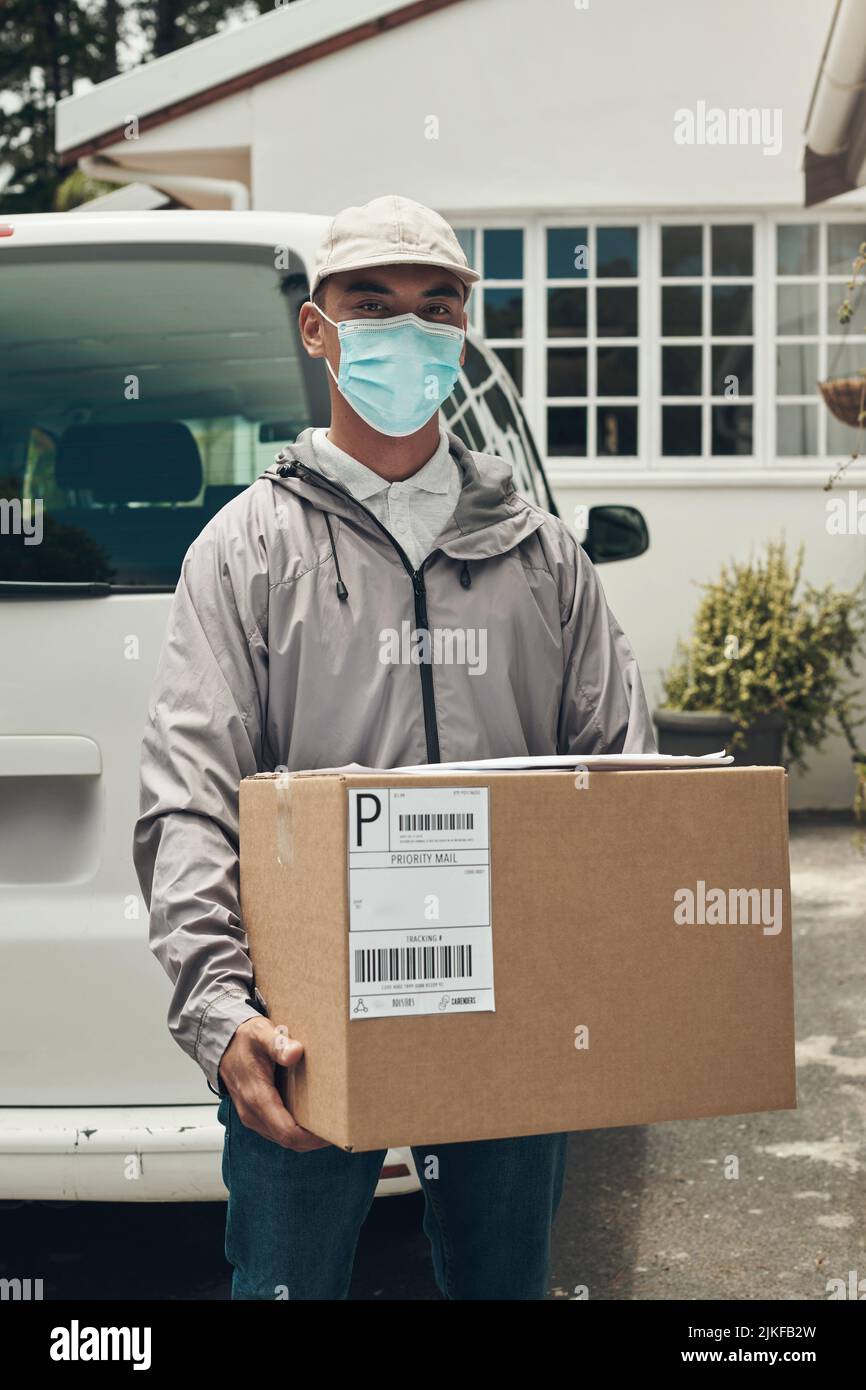 Making sure our customers are safe. a young man delivering a package to ... Making sure our customers are safe. a young man delivering a package to ...