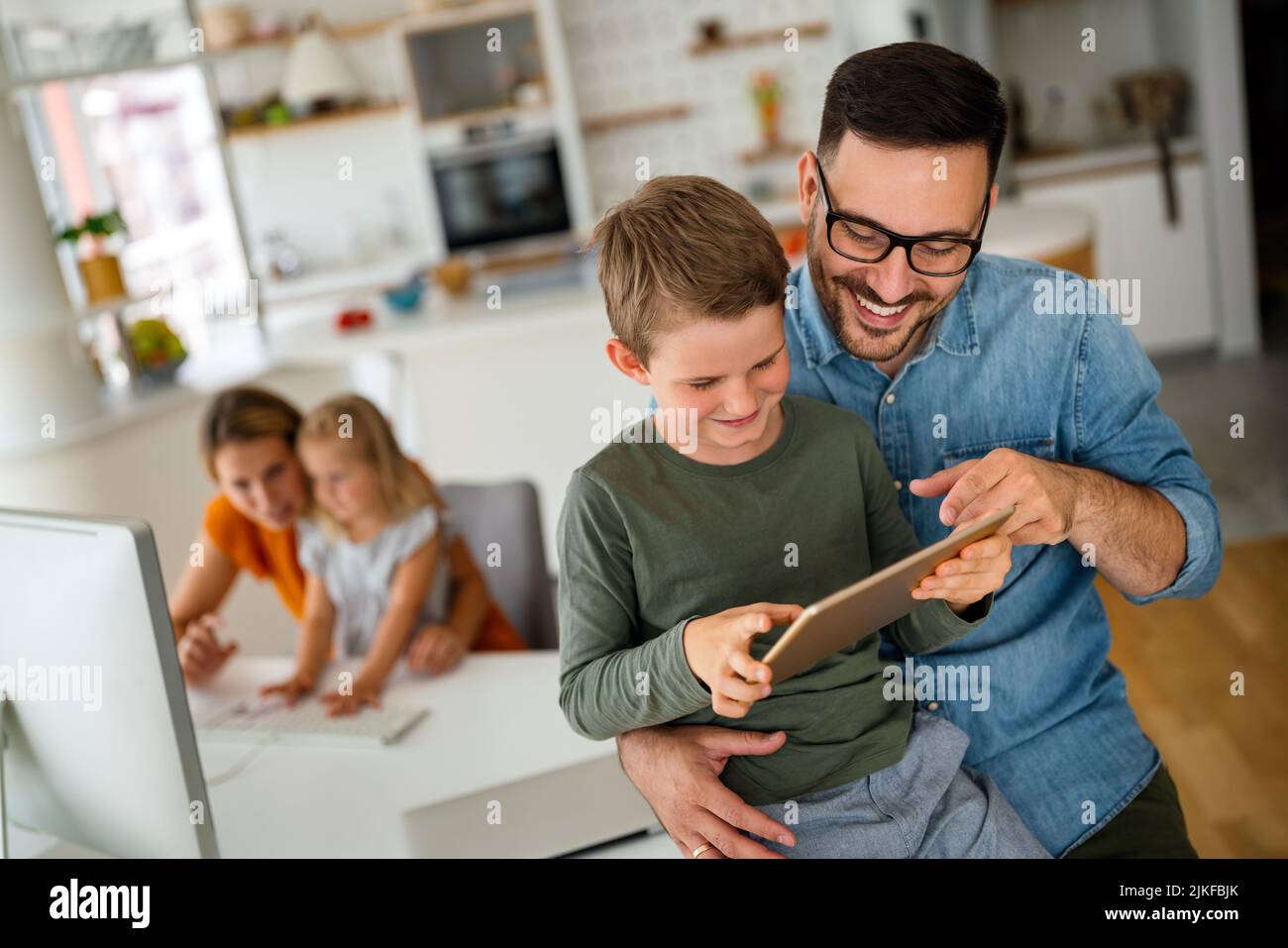 Father and child using digital tablet for e-learning. Education home digital device kid concept ...