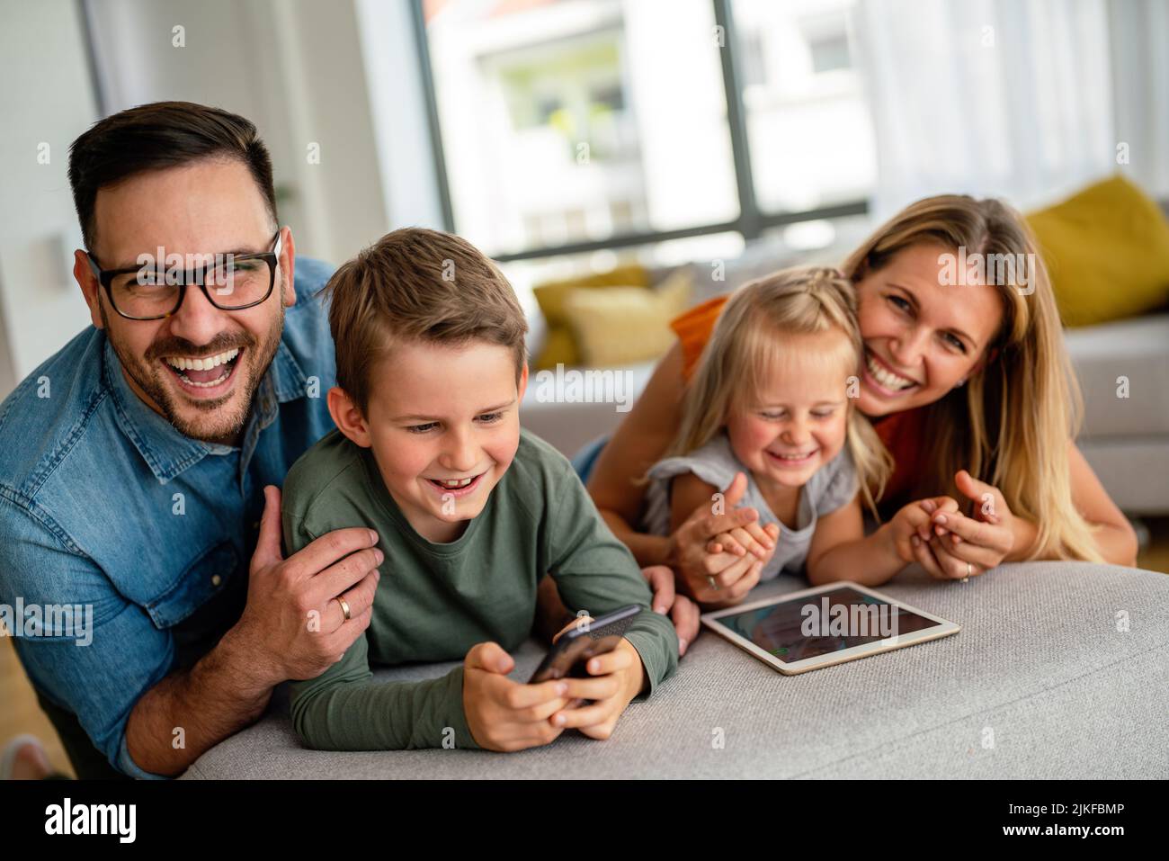 Device technology family online education concept. Happy family with ...