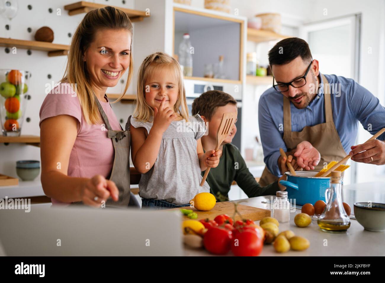 Happy family preparing healthy food together in kitchen Stock Photo - Alamy