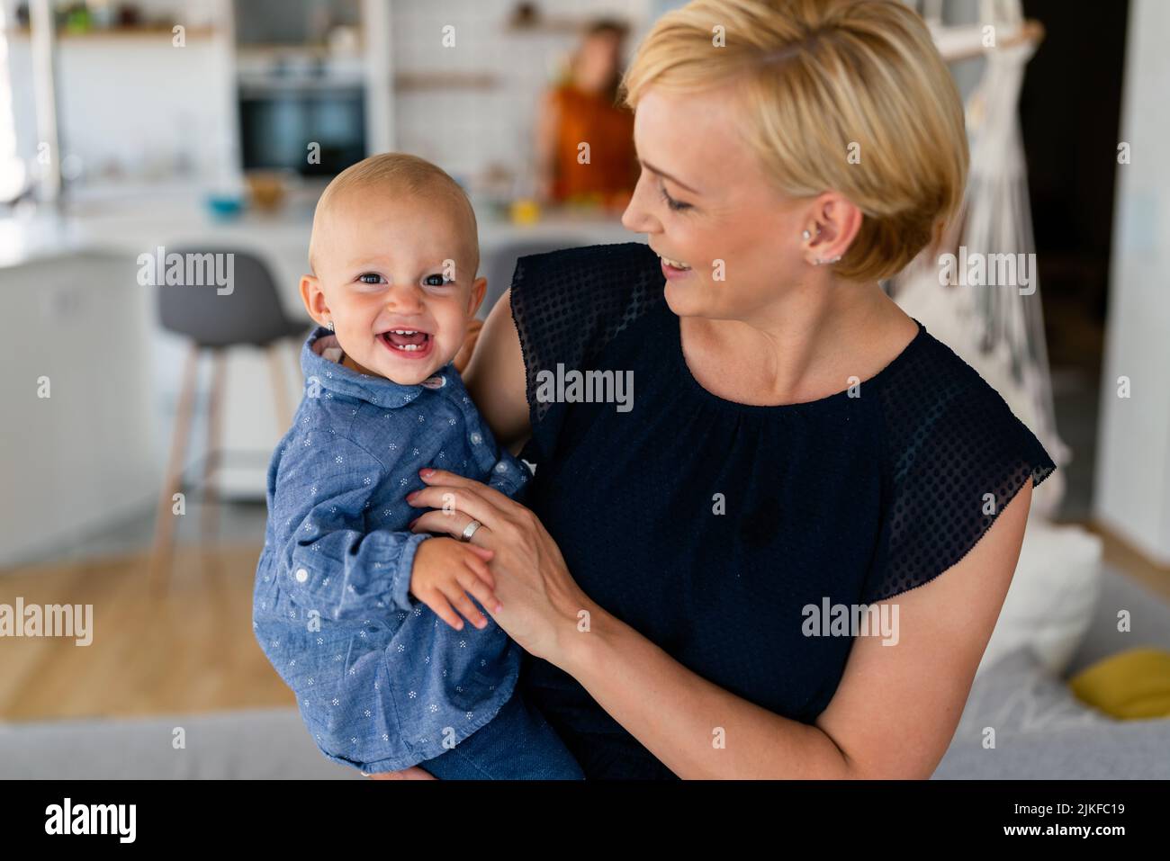 Happy family indoors. Portrait of beautiful mother with cute baby playing smiling together Stock ...