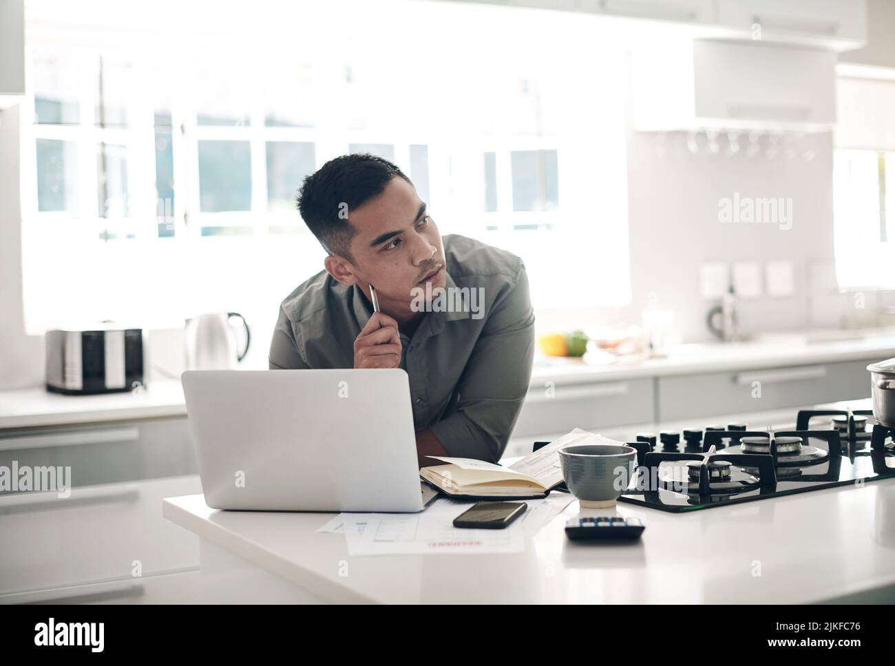 Doing some deeper thinking before making a decision. a young man using ...