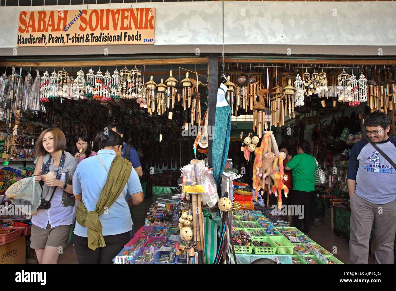 Tourists are photographed at a souvenir shop on the side of a road ...