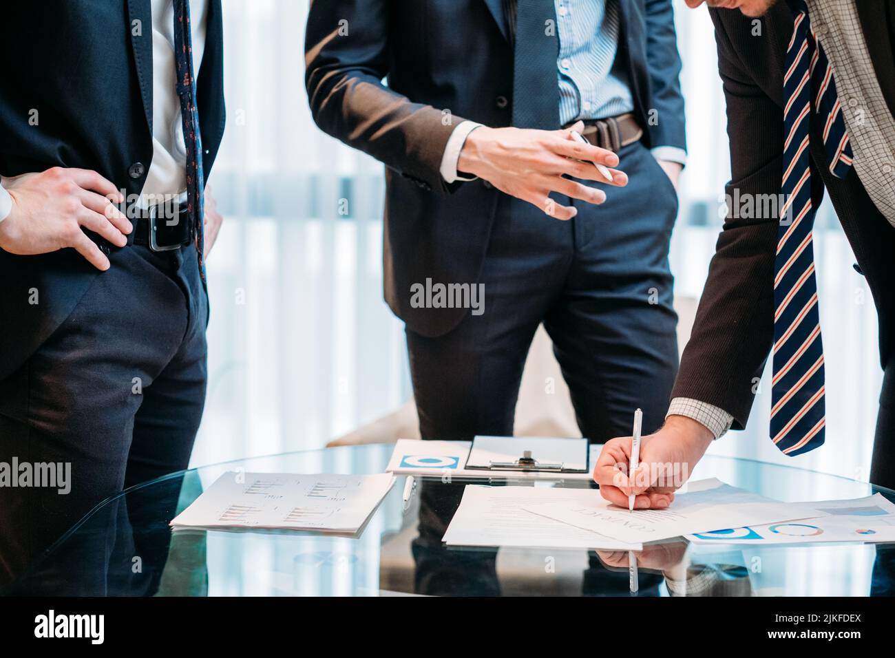 business partnership man sign contract shake hands Stock Photo - Alamy