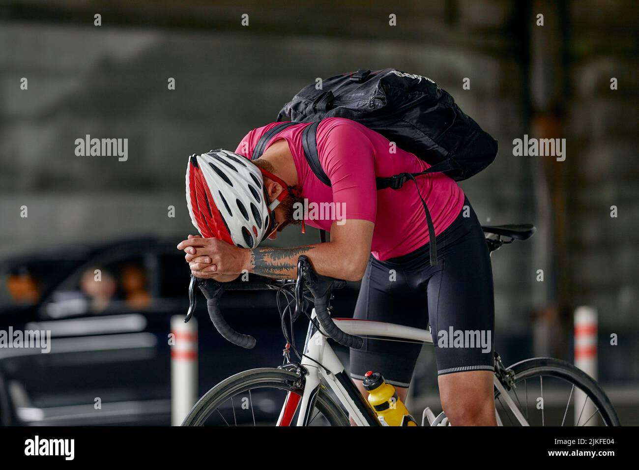 Stylish man walking around the city on bicycles on a weekend, riding on ...