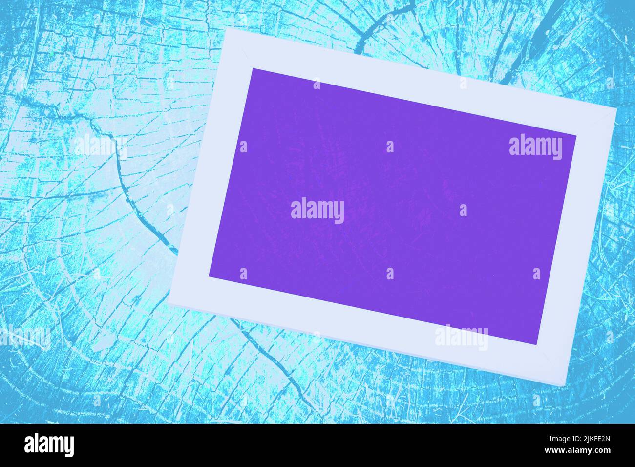 Purple screen neon and white frame TV monitor on an azure blue wooden ...