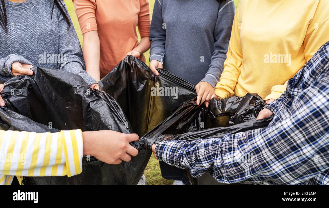 Asia Woman Group Team Volunteer picking up Trash plastics garbage ...