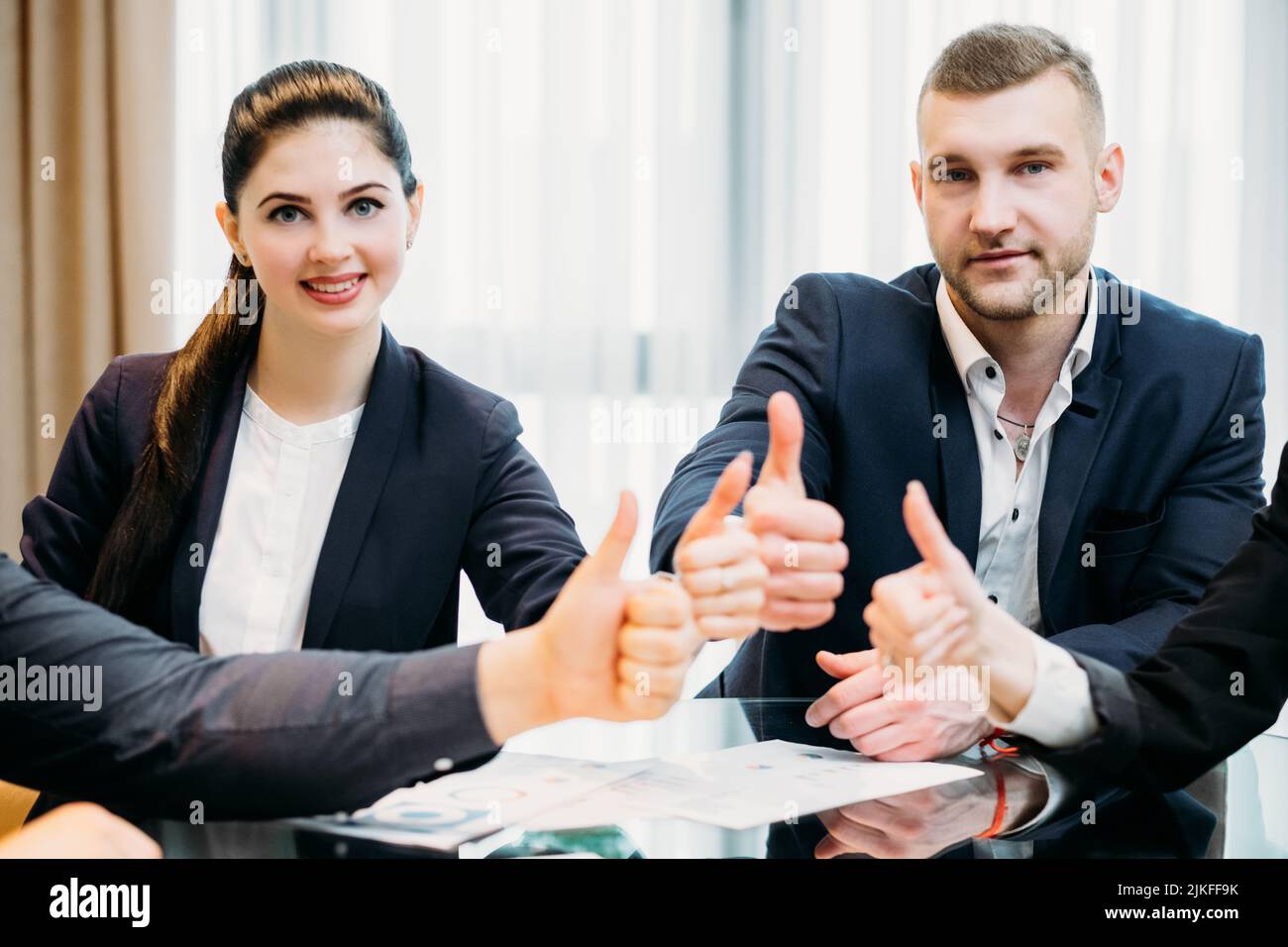 business men women thumb up professionals work Stock Photo - Alamy
