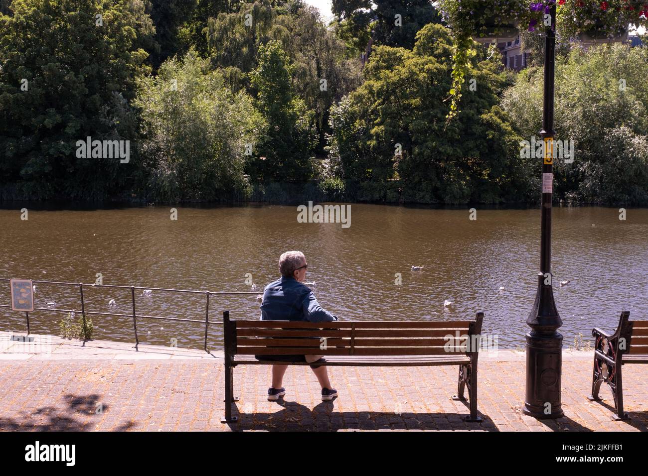 A lady relaxing at Groves on the River Dee at Chester, Chesire Stock ...