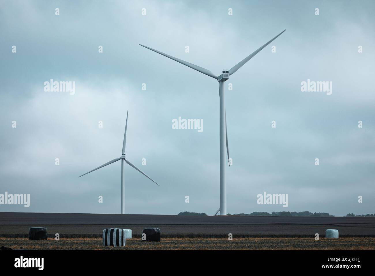 Wind turbine on a agricultural field with hay bale in France Stock ...