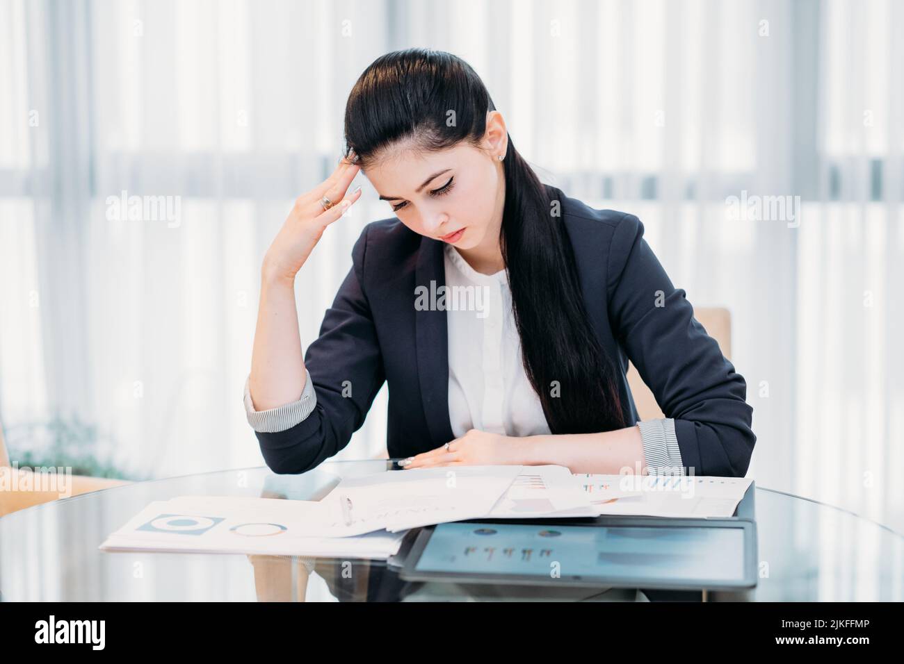tired business woman studying report papers office Stock Photo - Alamy