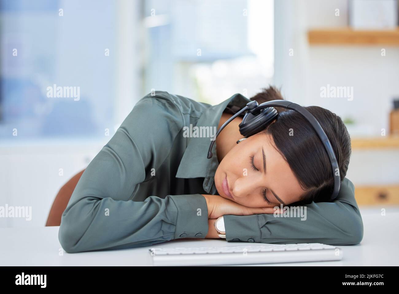 Just a little rest for my eyes. an exhausted businesswoman taking a nap ...