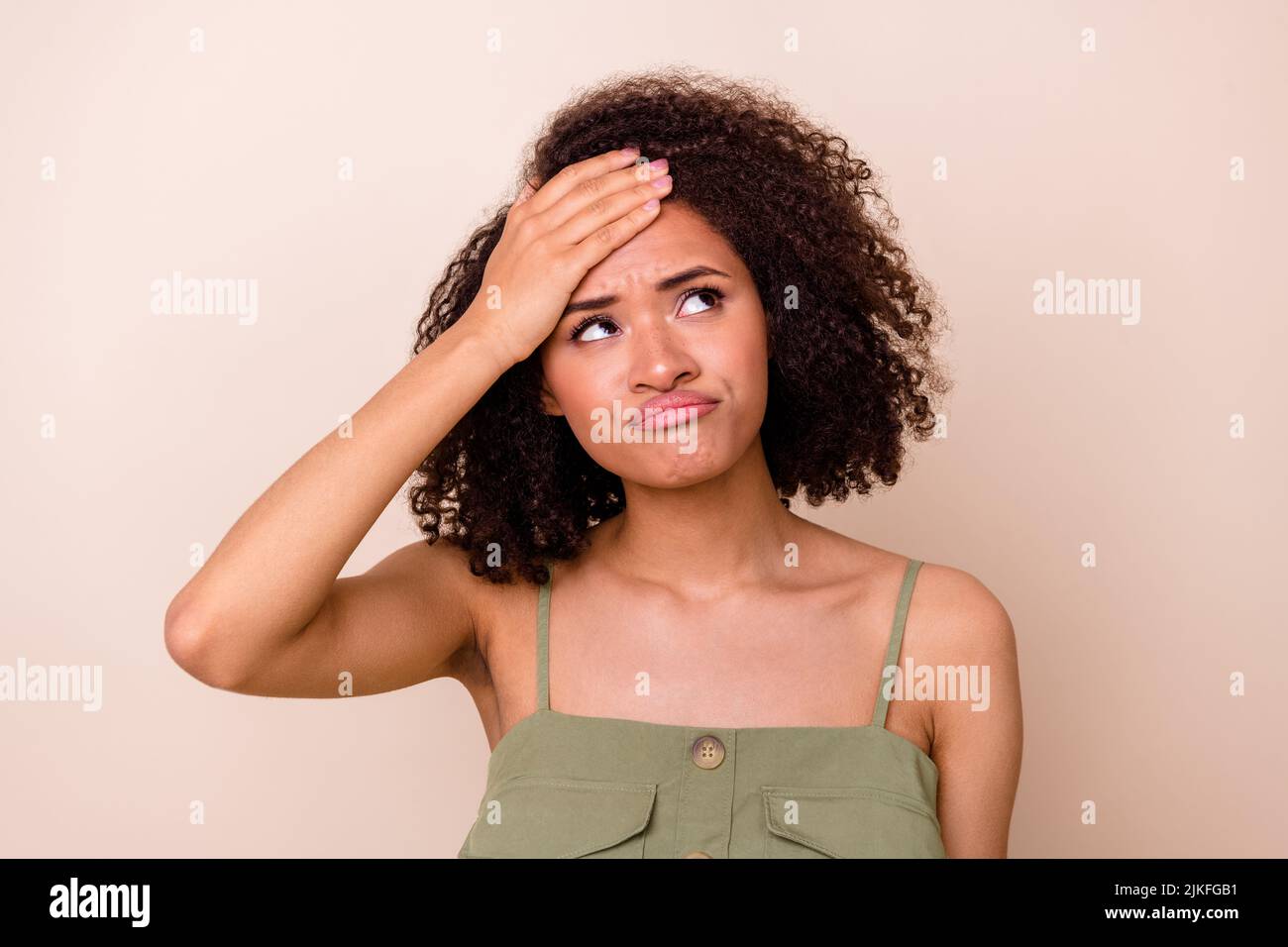 Portrait of dissatisfied moody girl hand touch forehead look empty ...