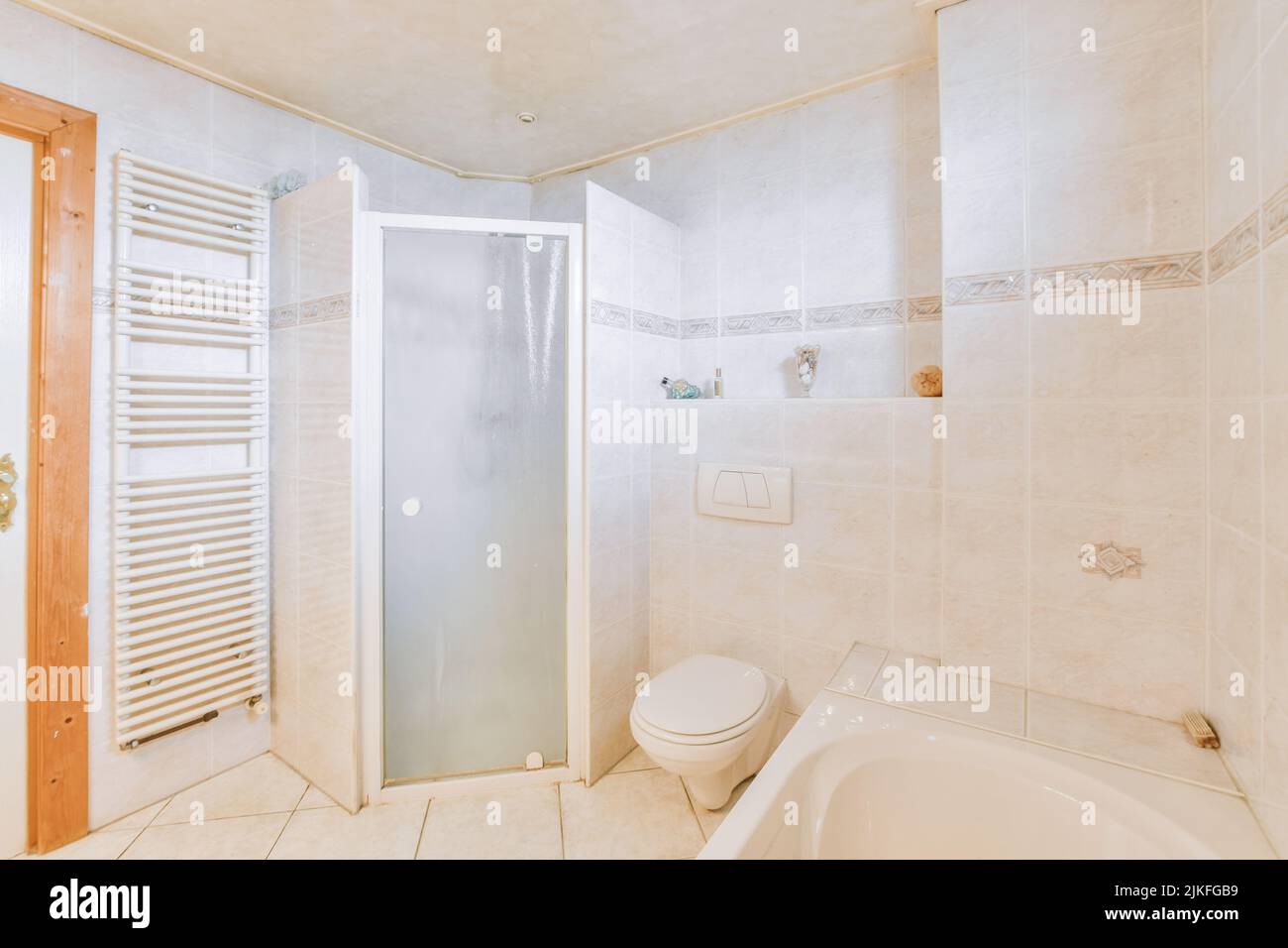 Sinks With Mirrors And Clean Bathtub Located Near Shower Box With Glass