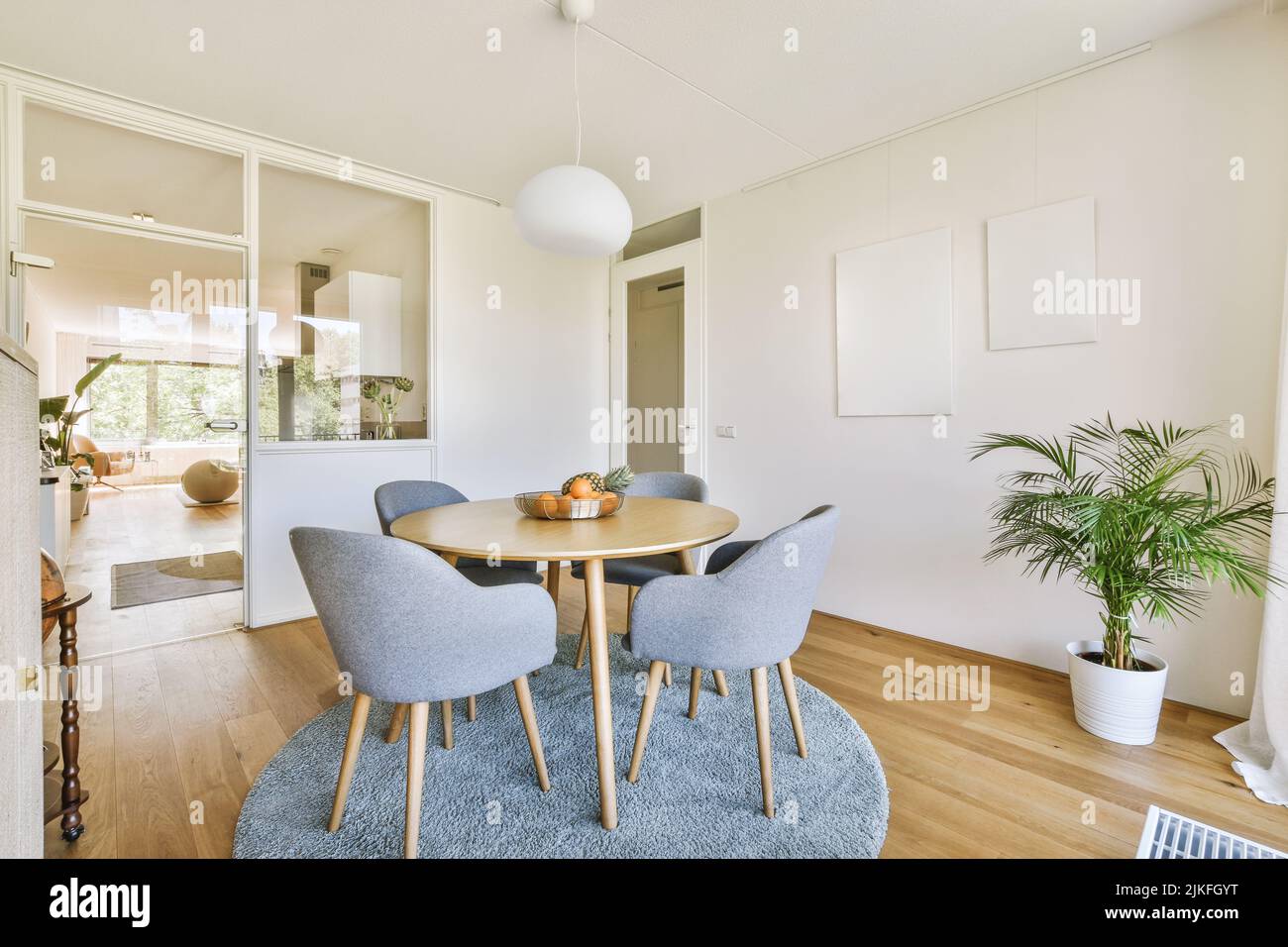 Couch and armchairs placed around table with decorations in dining area ...