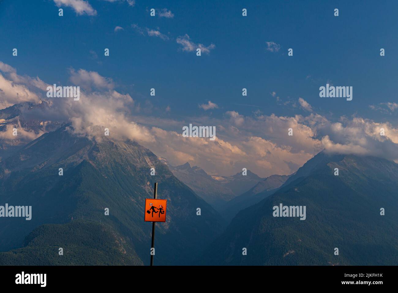Summer sunset between the clouds in the mountains of Valle d'Aosta ...