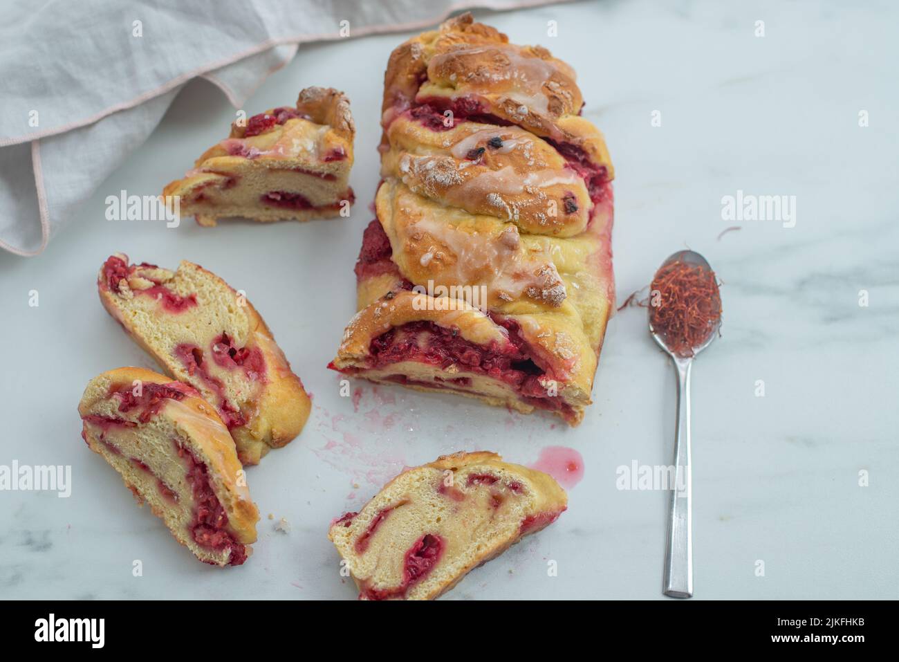 Sweet home made saffron raspberry babka on a table Stock Photo - Alamy