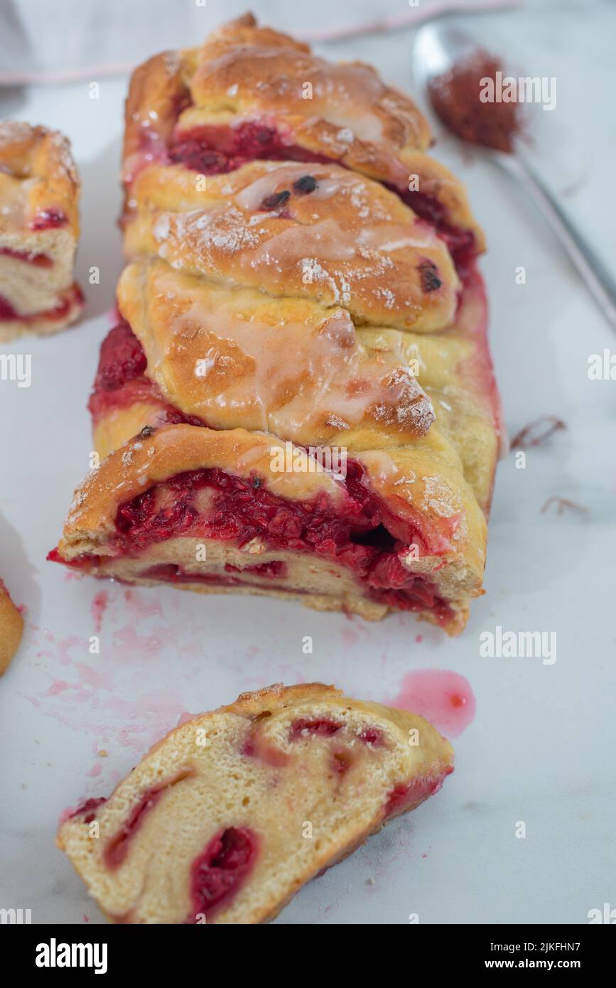 Sweet home made saffron raspberry babka on a table Stock Photo - Alamy
