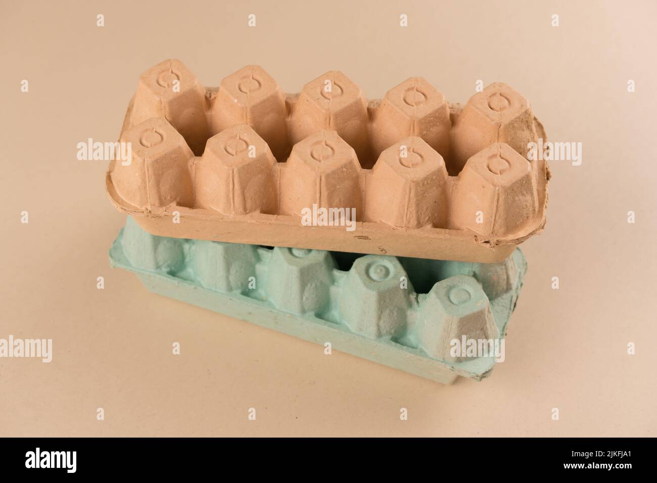 Pulp egg cartons made with pulp and natural straw over light brown ...
