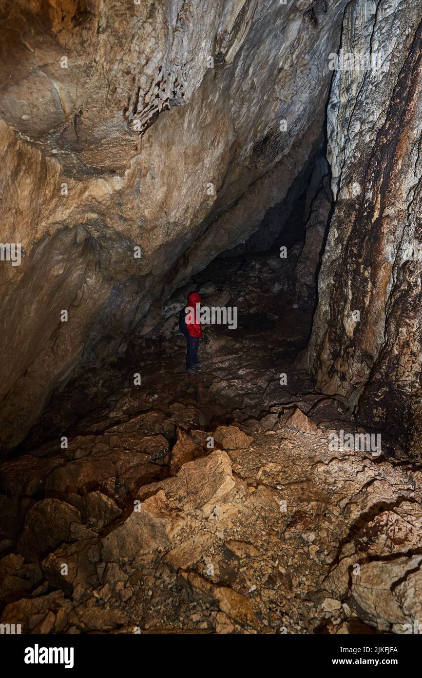 Woman with headtorch exploring a very old cave with beautiful ...