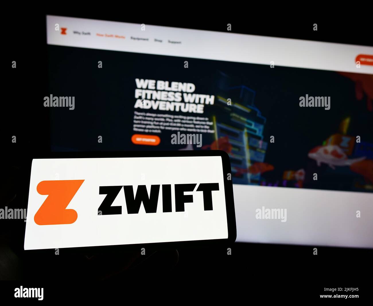 Person holding cellphone with logo of US fitness gaming company Zwift ...