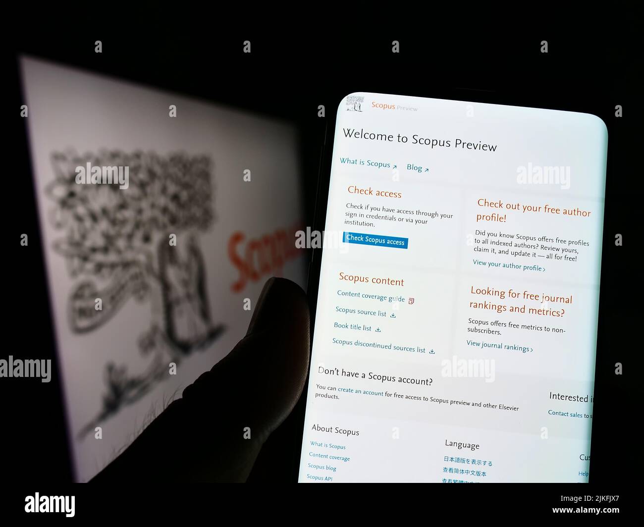Person holding cellphone with webpage of citation database Scopus ...