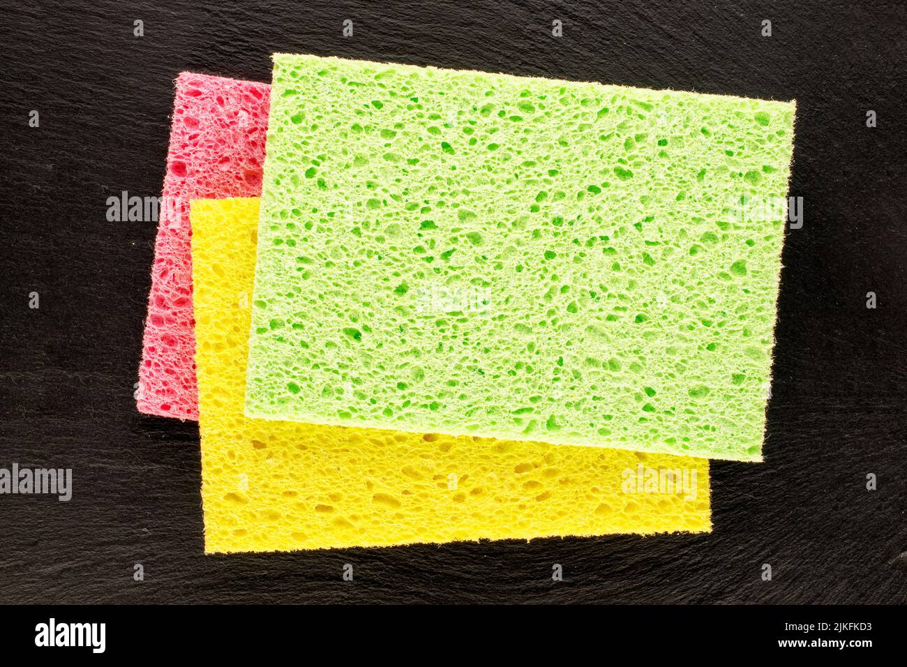 Three cellulose sponges on a slate stone, close-up, top view Stock ...