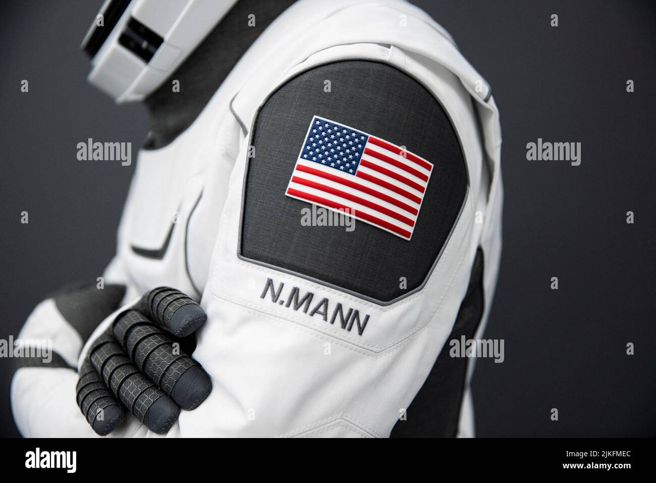 A SpaceX launch and entry suit bears an American flag, and the name of ...