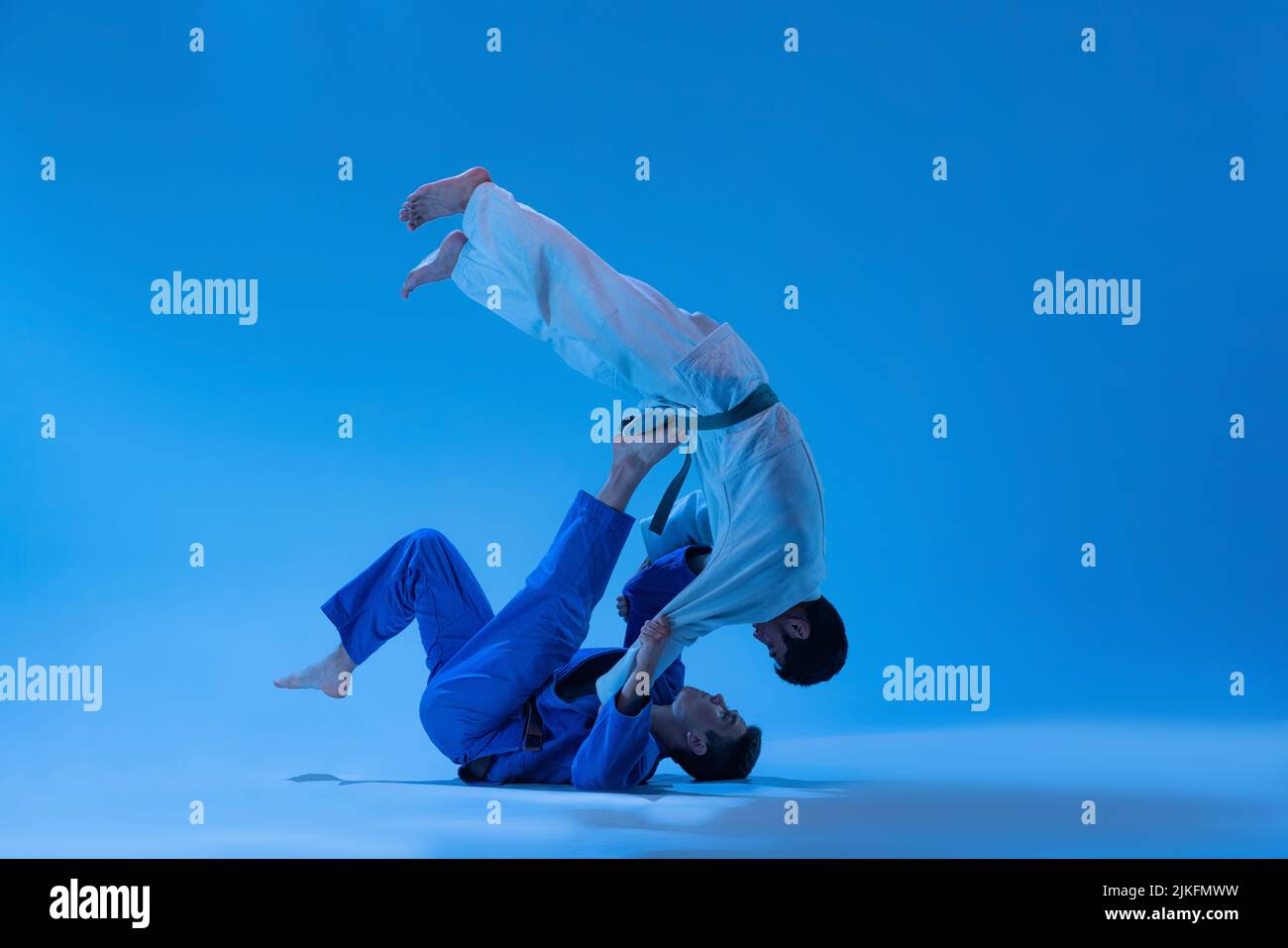 Dynamic portrait of professional judo coach training with athlete ...